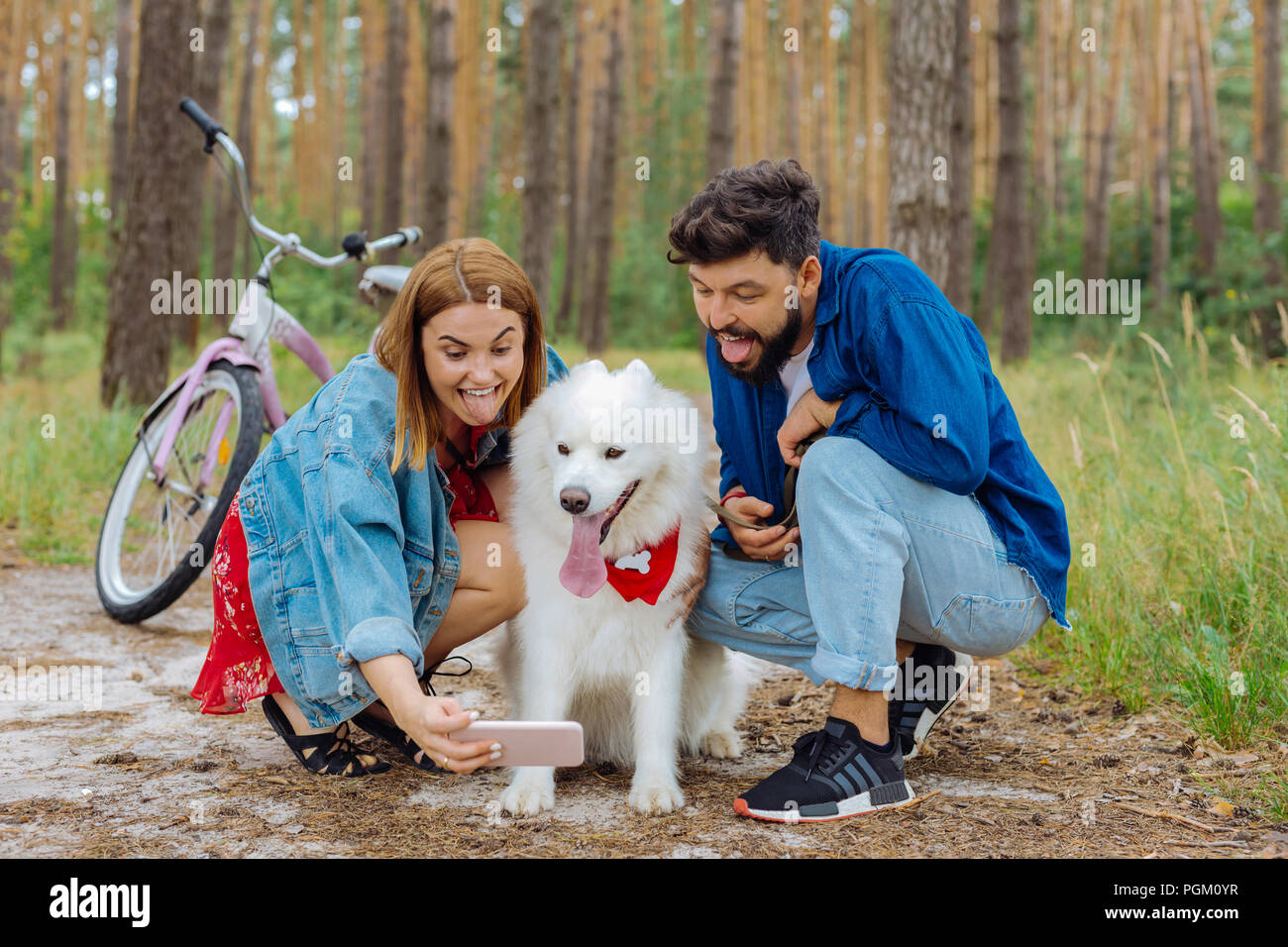Cute couple making funny faces while making photo together Stock Photo ...