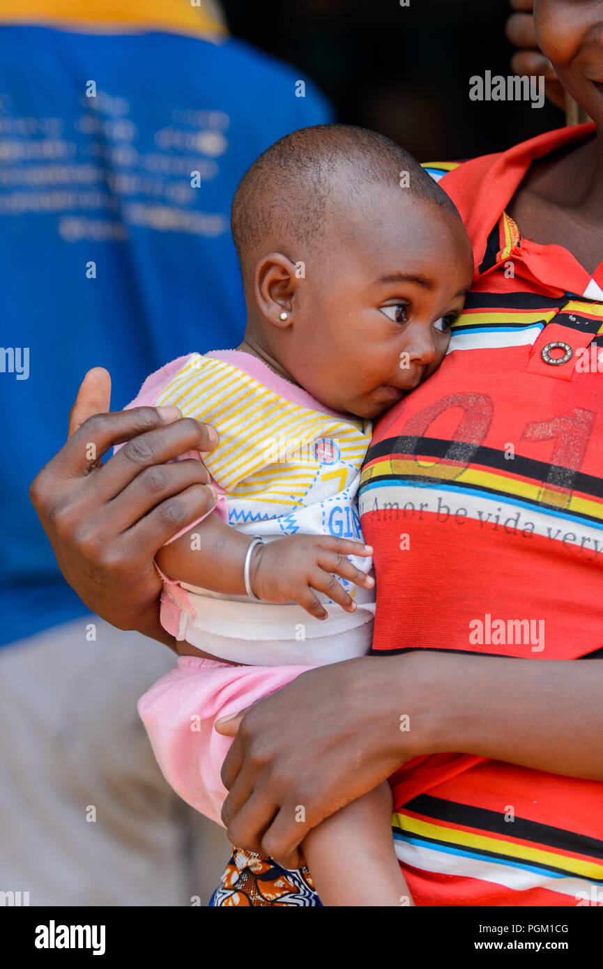 PIRA, BENIN - JAN 12, 2017: Unidentified Beninese baby girl is carried ...