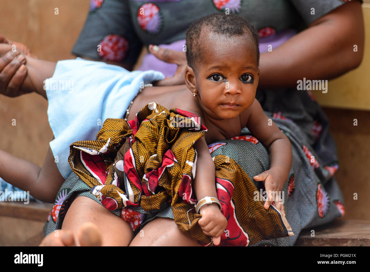 PIRA, BENIN - JAN 12, 2017: Unidentified Beninese baby girl is carried ...