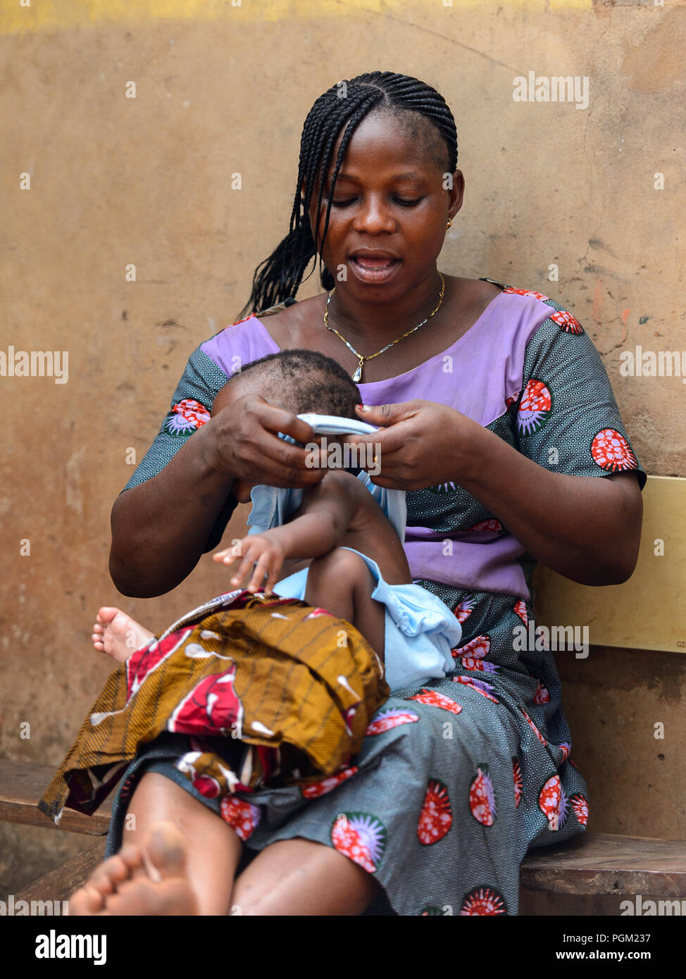 PIRA, BENIN - JAN 12, 2017: Unidentified Beninese baby girl is carried ...