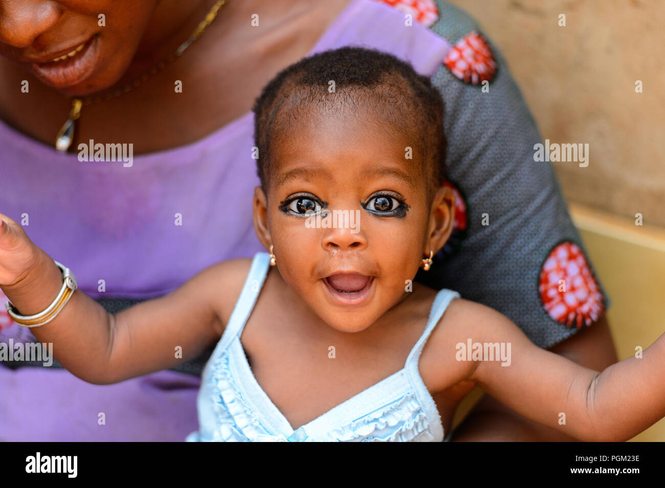 PIRA, BENIN - JAN 12, 2017: Unidentified Beninese baby girl is carried ...