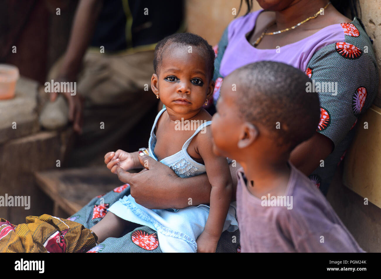 PIRA, BENIN - JAN 12, 2017: Unidentified Beninese baby girl is carried ...