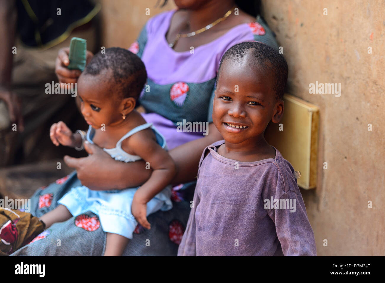 PIRA, BENIN - JAN 12, 2017: Unidentified Beninese baby girl is carried ...