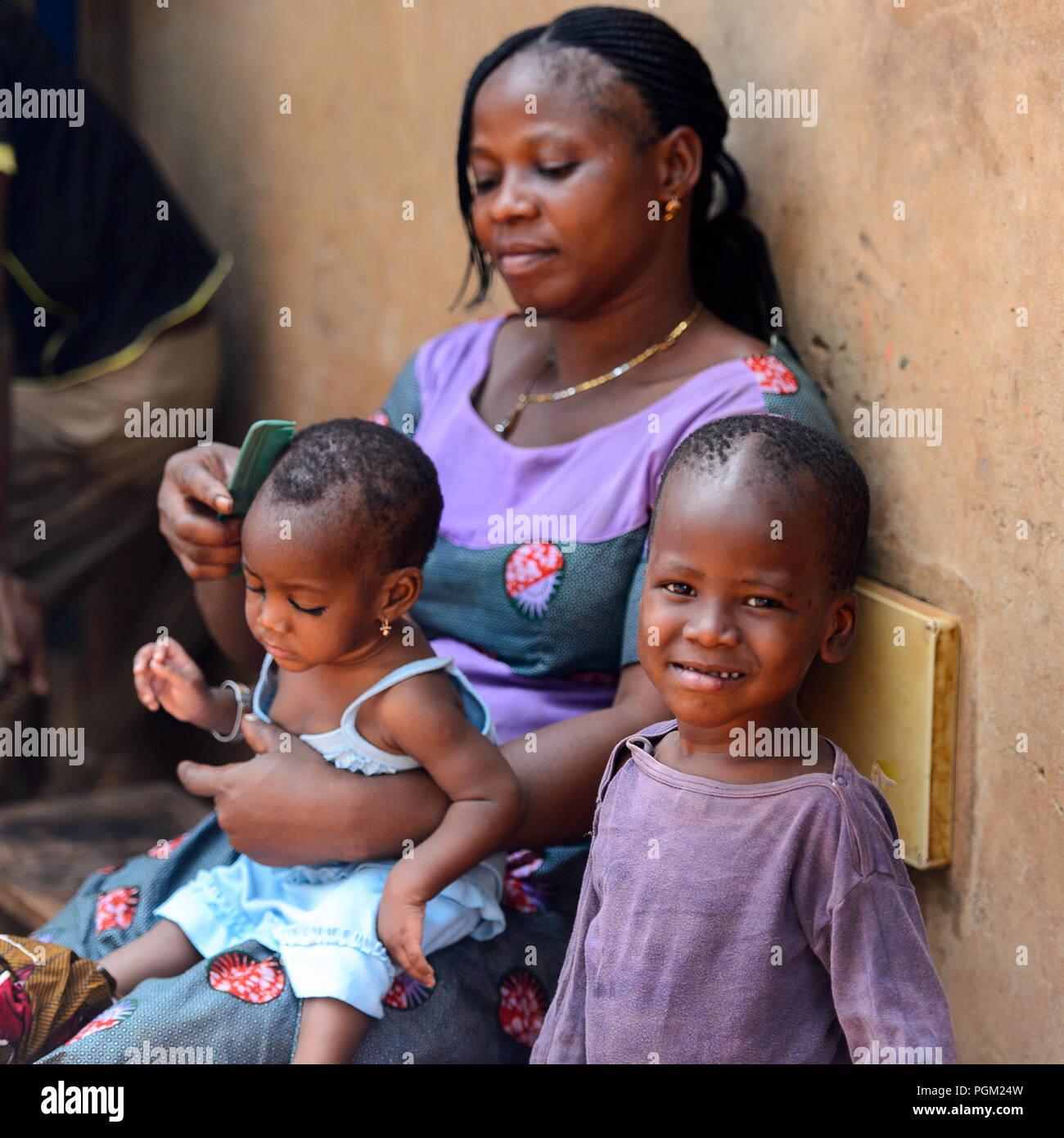 PIRA, BENIN - JAN 12, 2017: Unidentified Beninese baby girl is carried ...