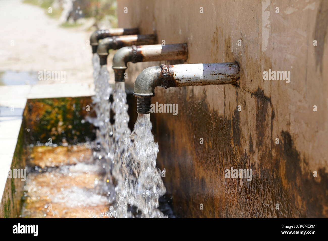 Natural spring water flowing from 4 pipes at the same time in central ...