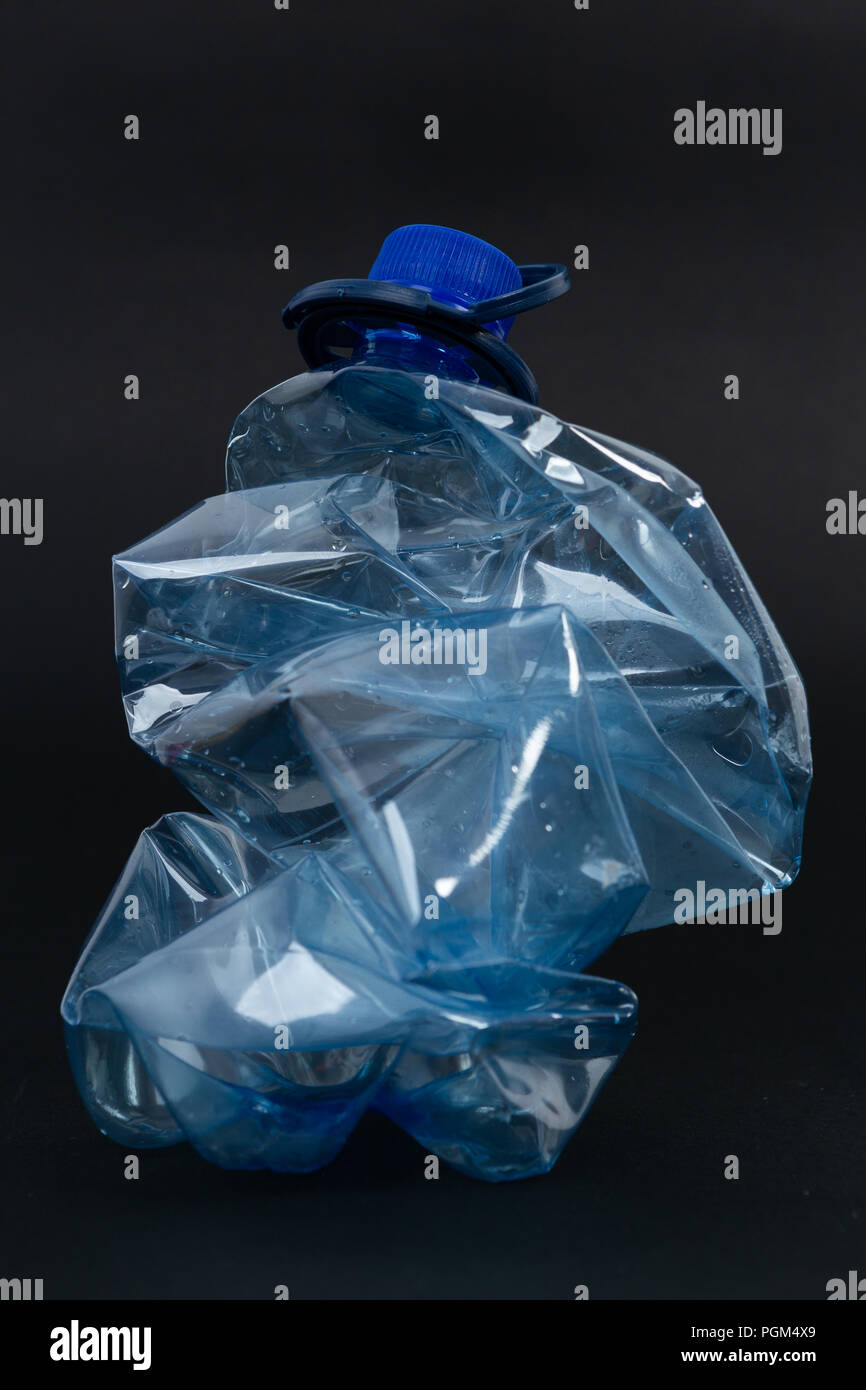 Crumpled recyclable plastic blue water beverage pet bottle as recycling ...