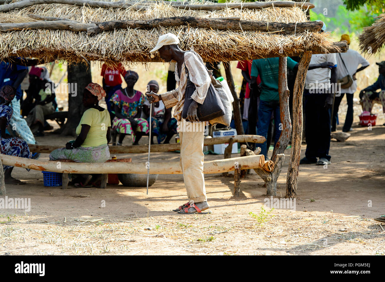 KOUTAMMAKOU, TOGO - JAN 13, 2017: Unidentified Togolese people sit in ...