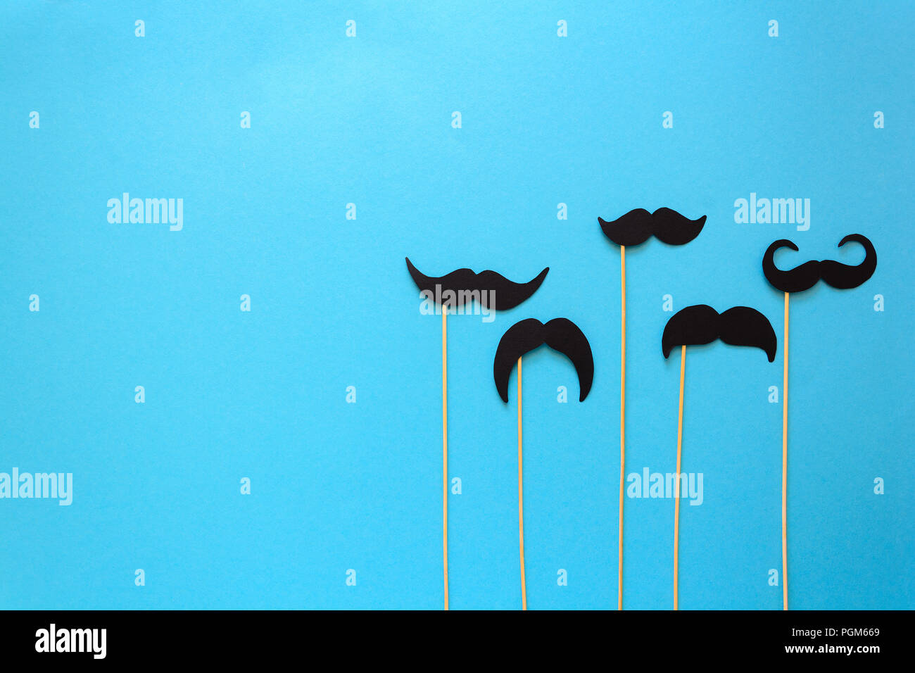 Paper moustache on booth props on blue paper background. Cut out style ...