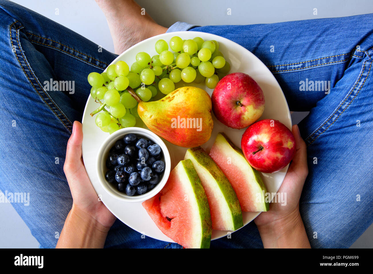Woman's hands holding plate with summer fruits: watermelon, blueberry ...