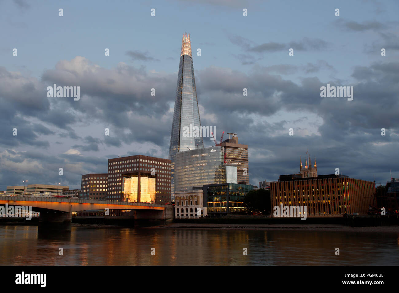 The Shard and number 1 London Bridge reflecting the low setting sun in ...