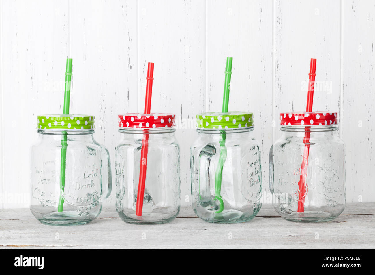Empty mason jars for lemonade or smoothie. In front of wooden wall with ...