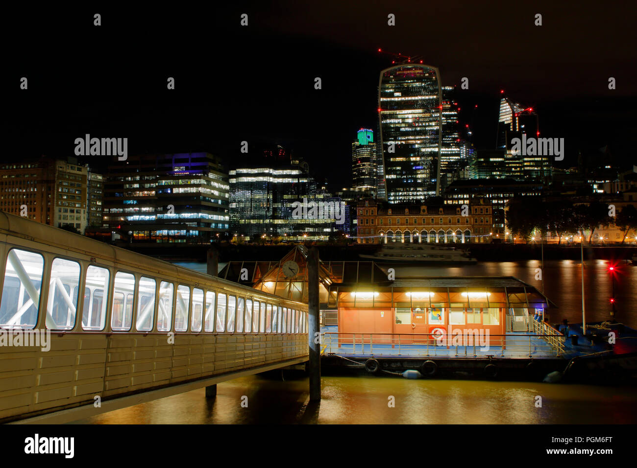 London Bridge river boat stop on a floating pontoon at night, London ...