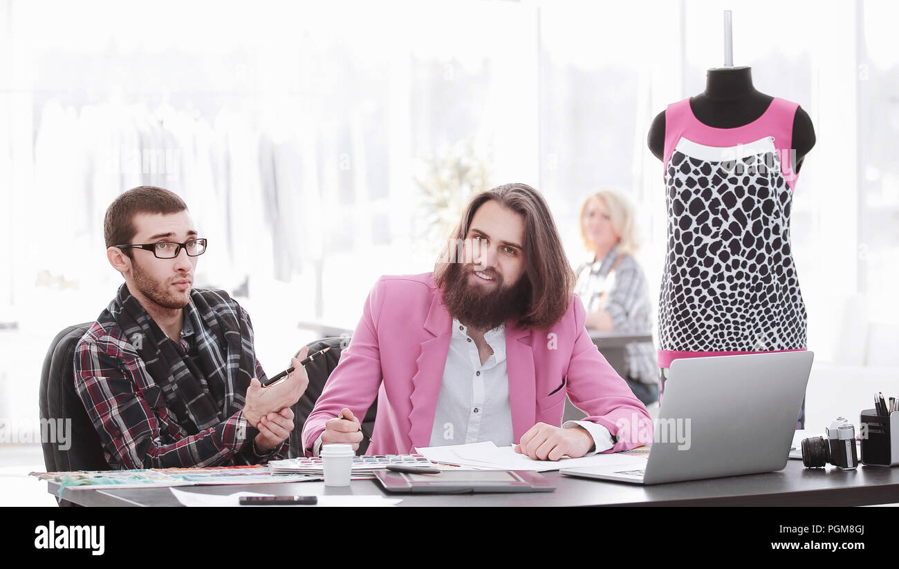 two fashion designers discussing designs of the new models Stock Photo ...