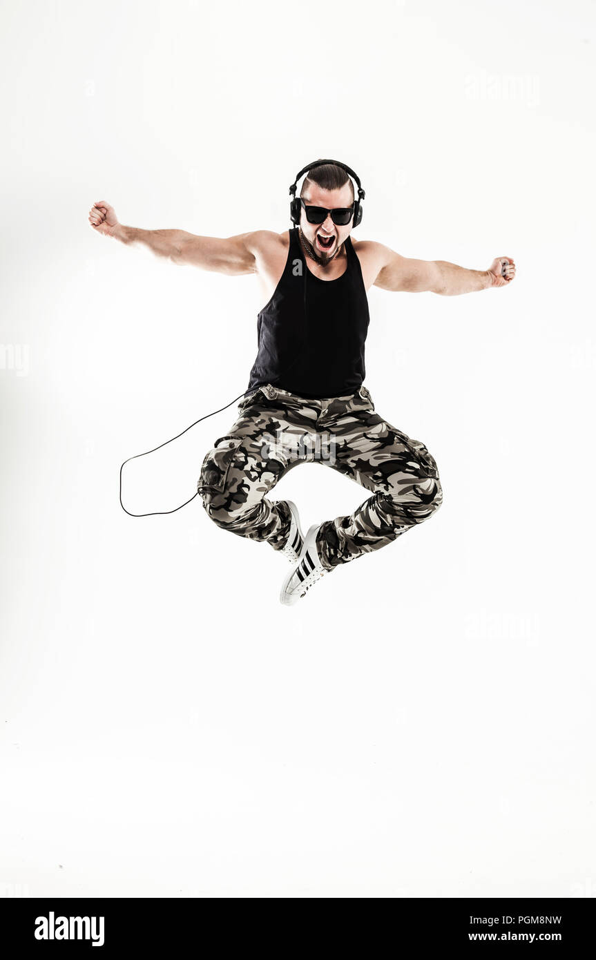 emotional and charismatic DJ - rapper with headphones on a white Stock ...