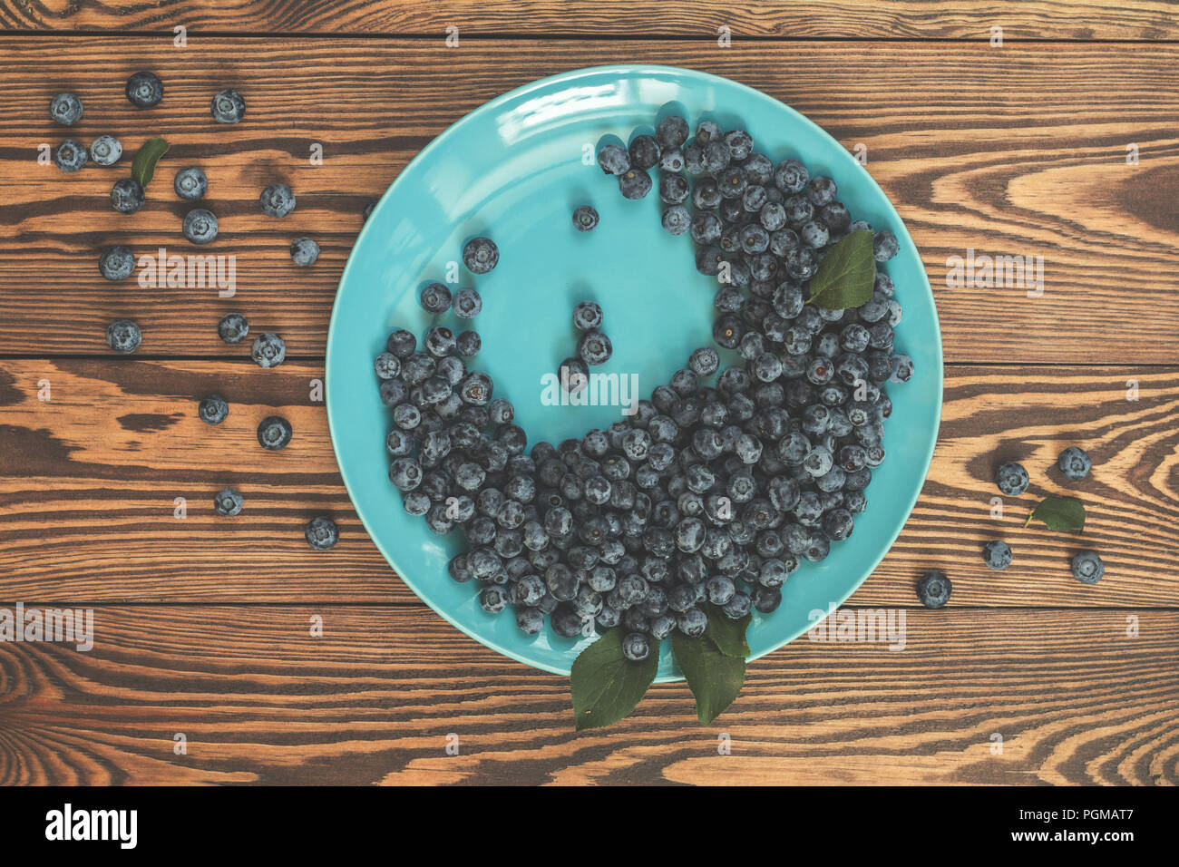 Many juicy beautiful amazing nice blueberries in blue dish on dark ...
