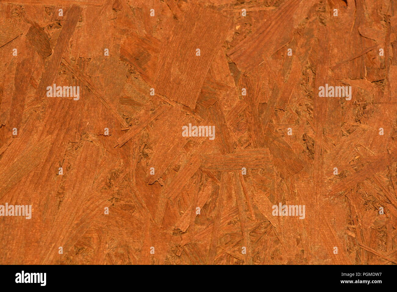 Construction oriented chipboard covered with brown varnish, original ...