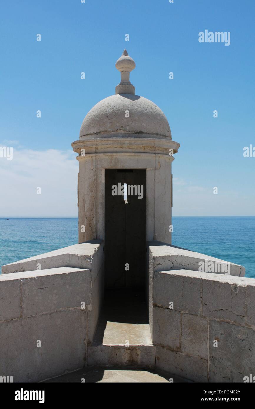 Watchtower of the fortress on the beach in Sesimbra village, Portugal ...