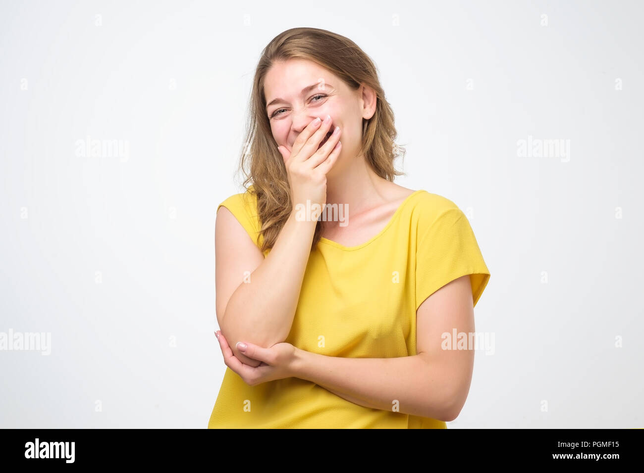 Young caucasian woman closing her mouth and wide open eye isolated on ...