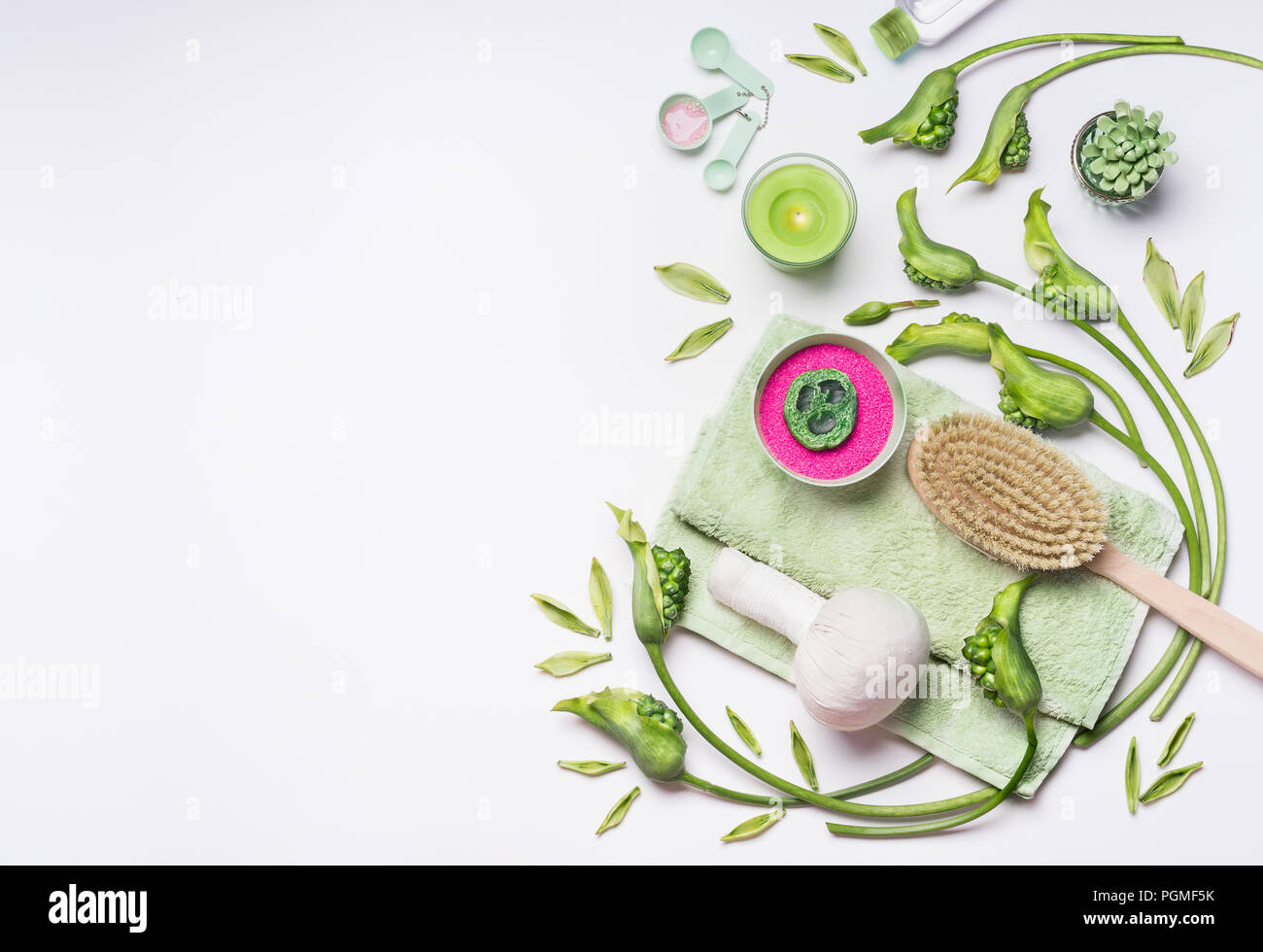 Spa setting with green flowers and plants, massage tools, sea salt ...