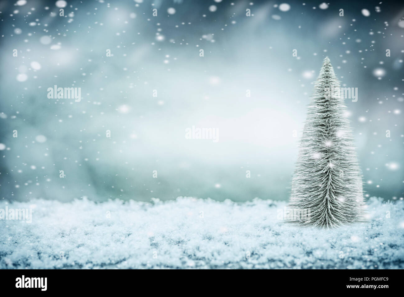 Winter snow background with Christmas tree, front view Stock Photo - Alamy