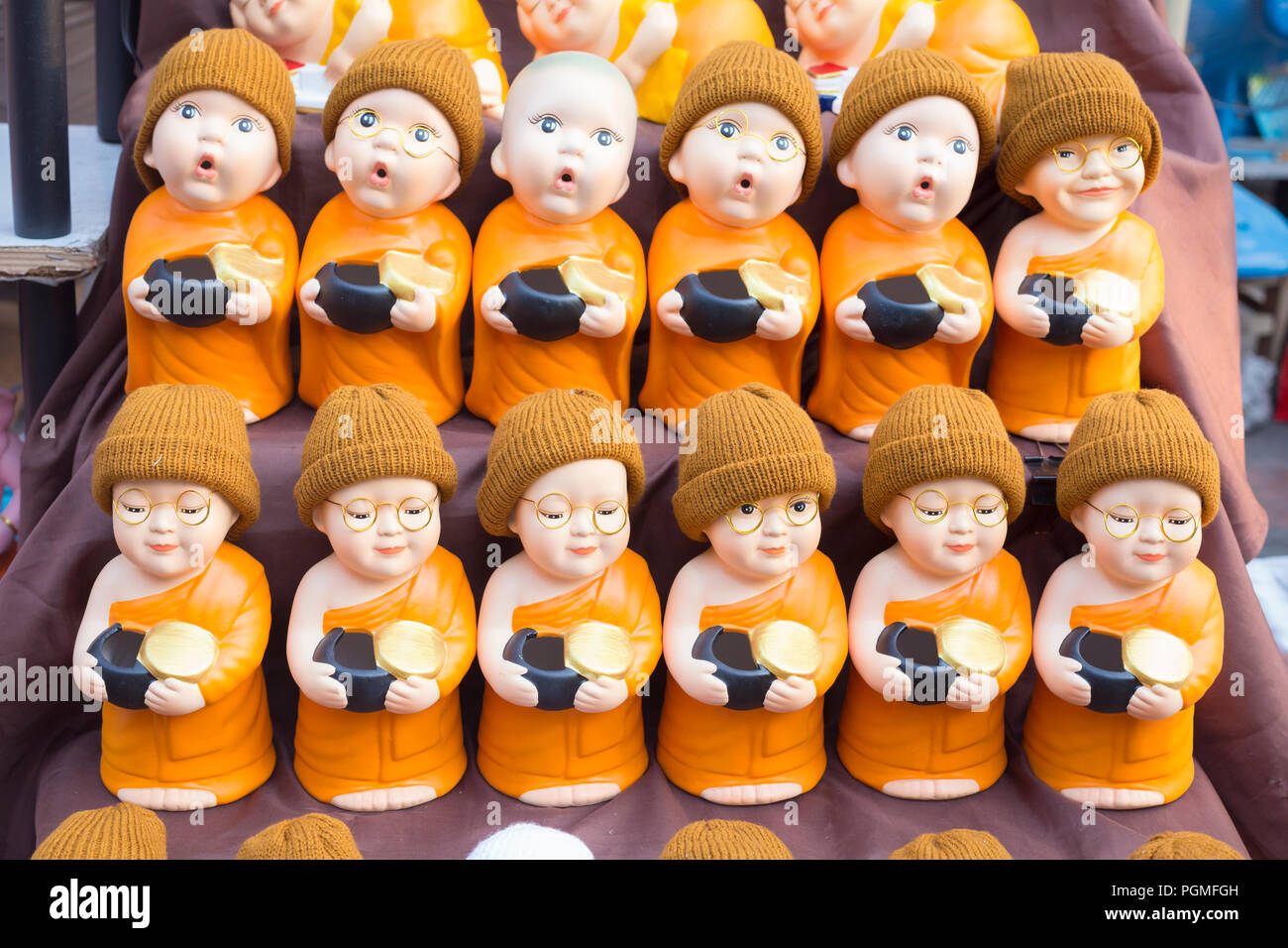 Monk toy puppets on display at a market in Thailand Stock Photo - Alamy