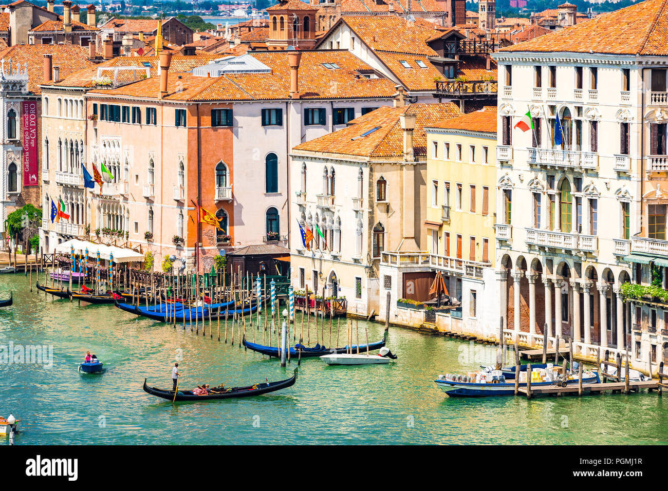 An aerial view of the iconic grand canal with gondolas in front of ...
