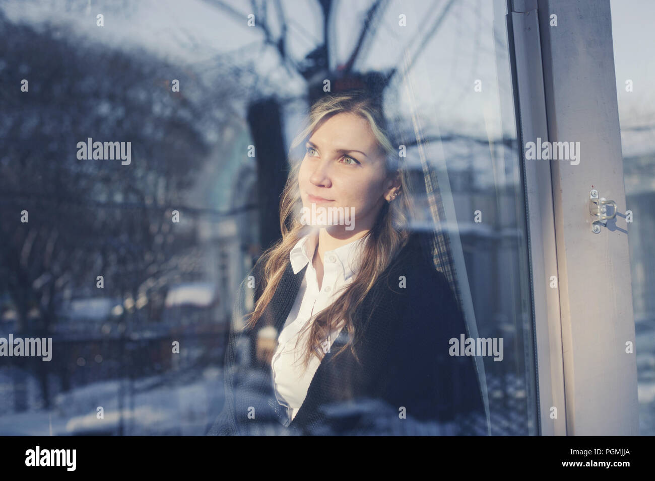 View through the window of a successful woman while relaxing in a cafe ...