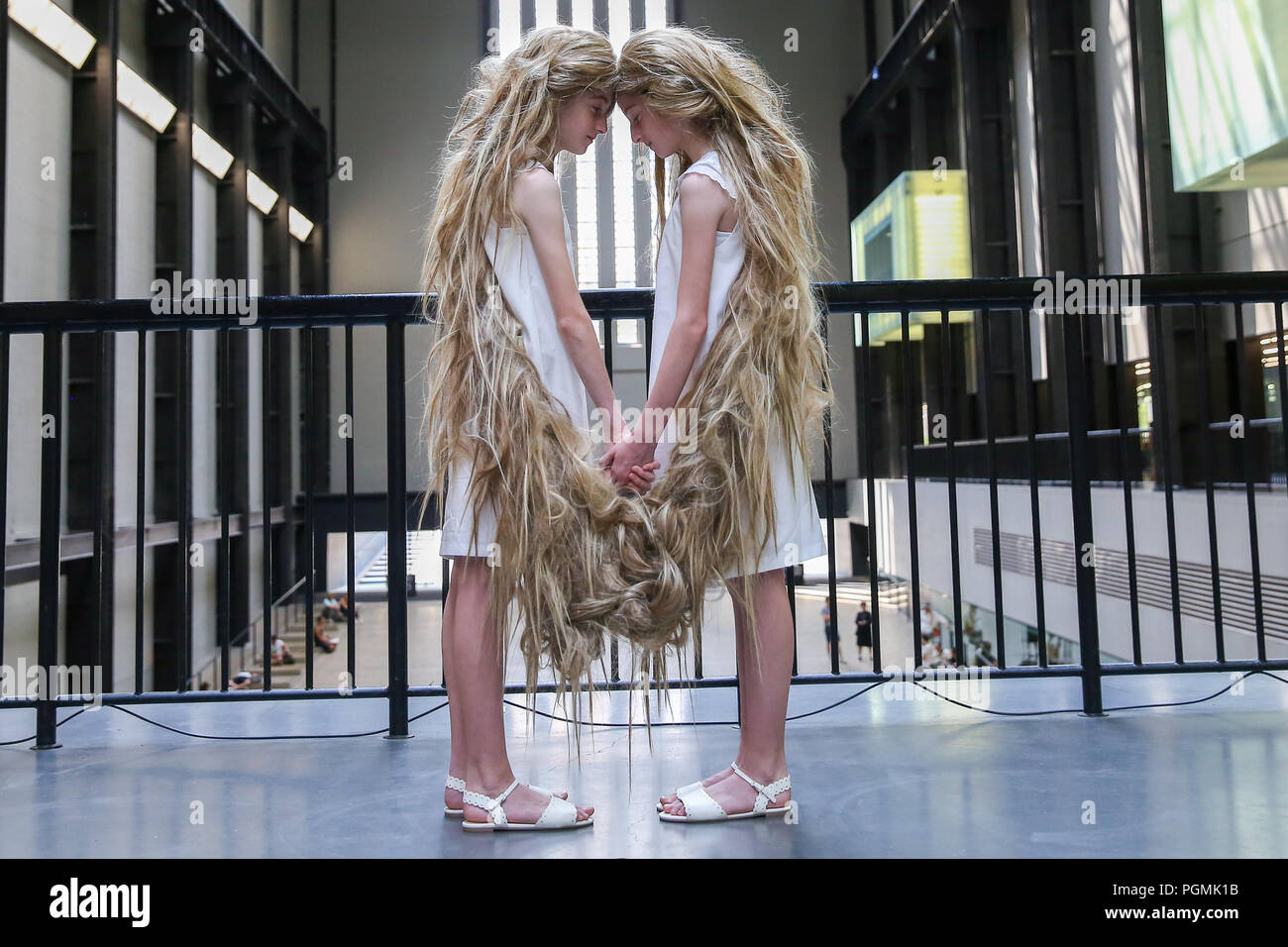 Brazilian artist Tunga’s performance featuring twins connected by their ...