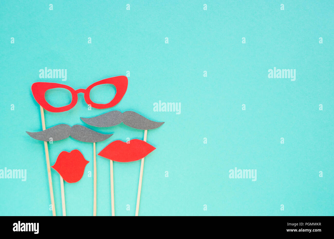 Colorful photo booth props glasses, lips and moustaches on blue ...