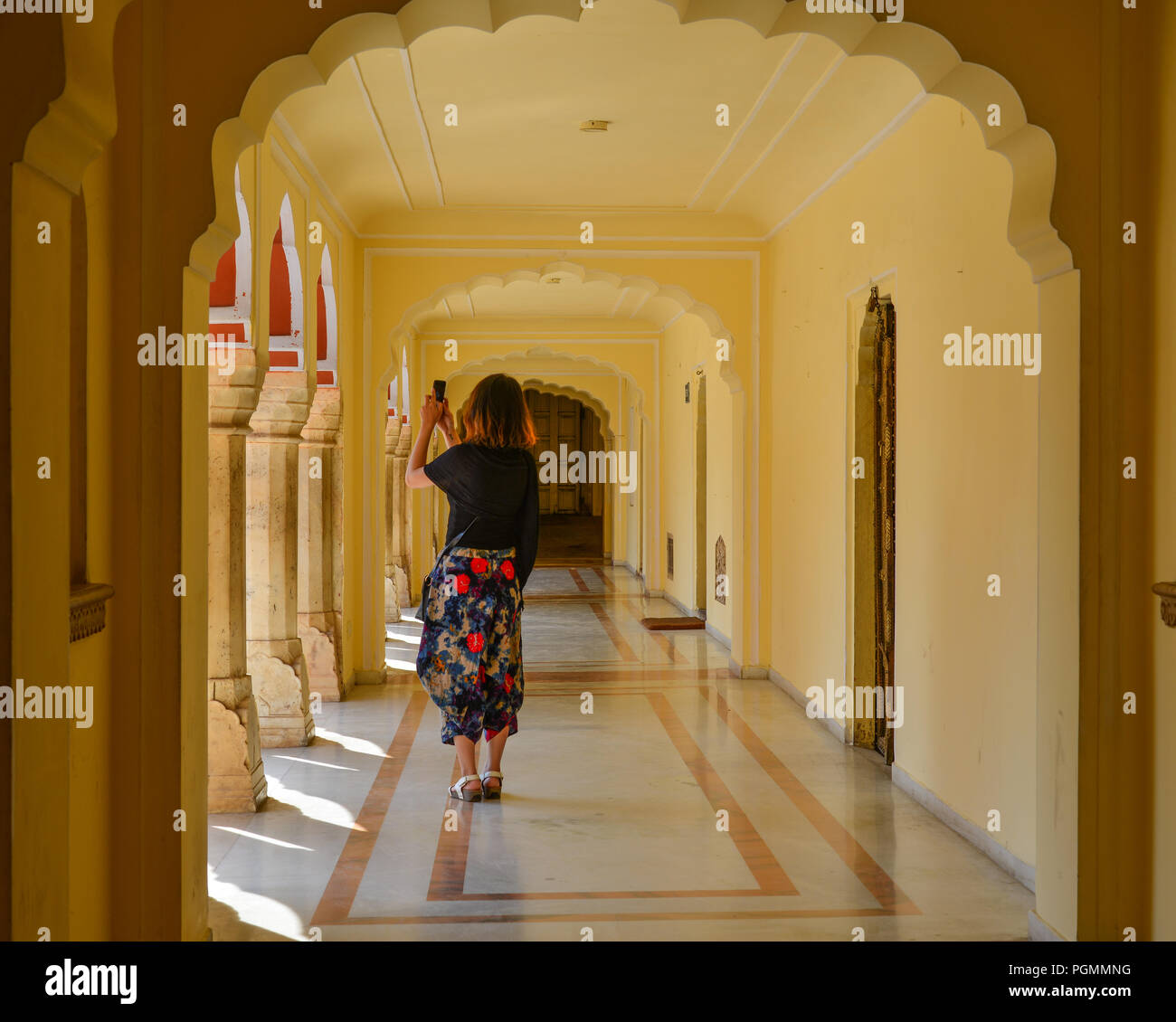 Jaipur, India - Nov 2, 2017. A young woman walking on the lobby of ...