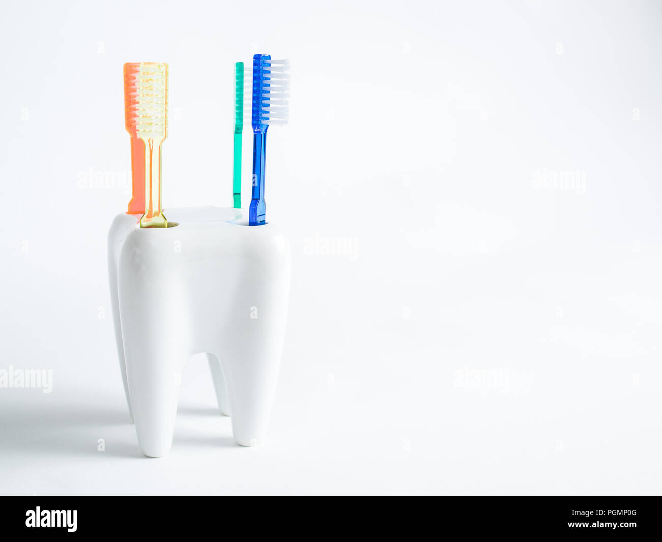 4 colored toothbrushes are standing in the glass, concept dental Stock ...