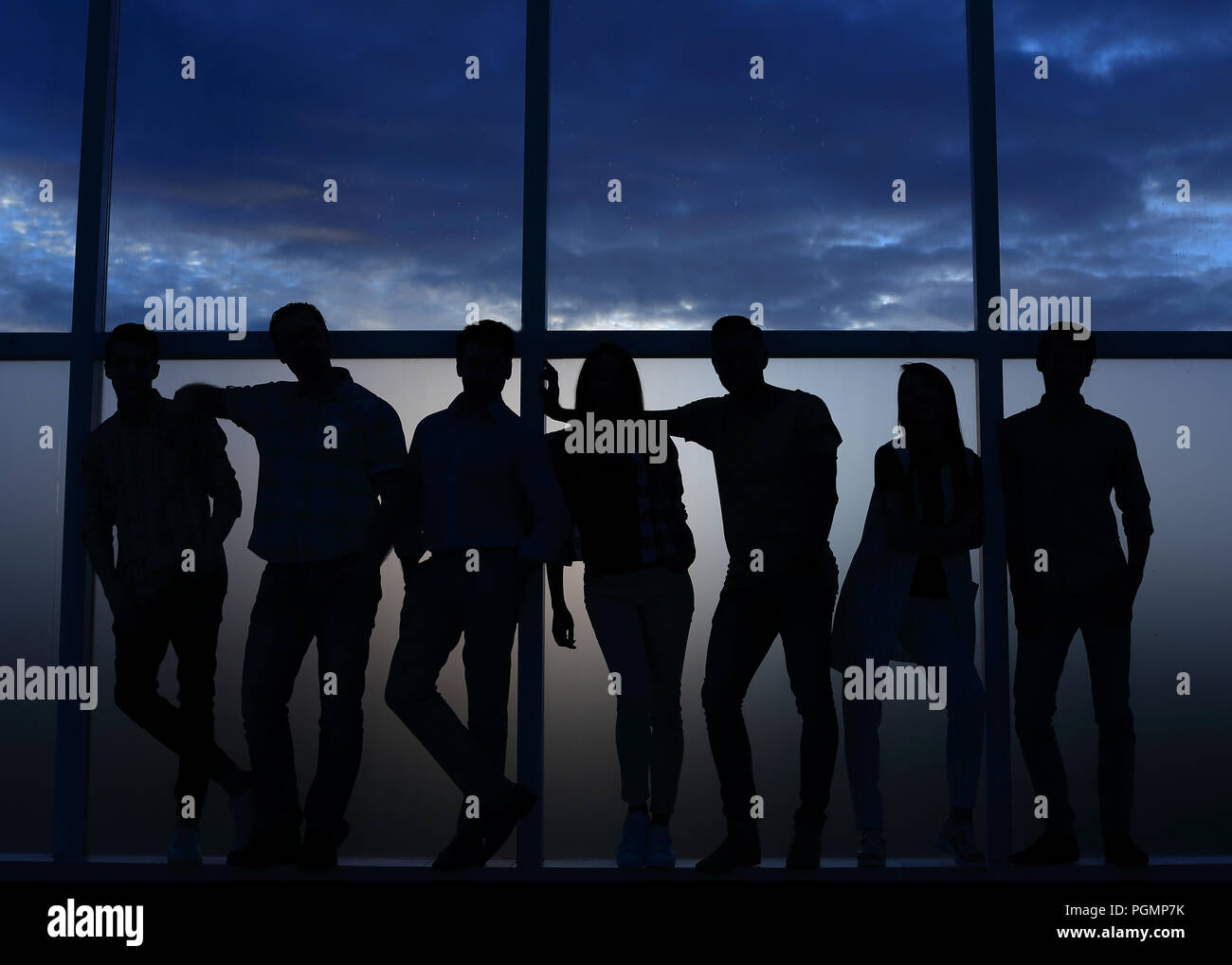 business team standing near the window, evening, dark Stock Photo - Alamy