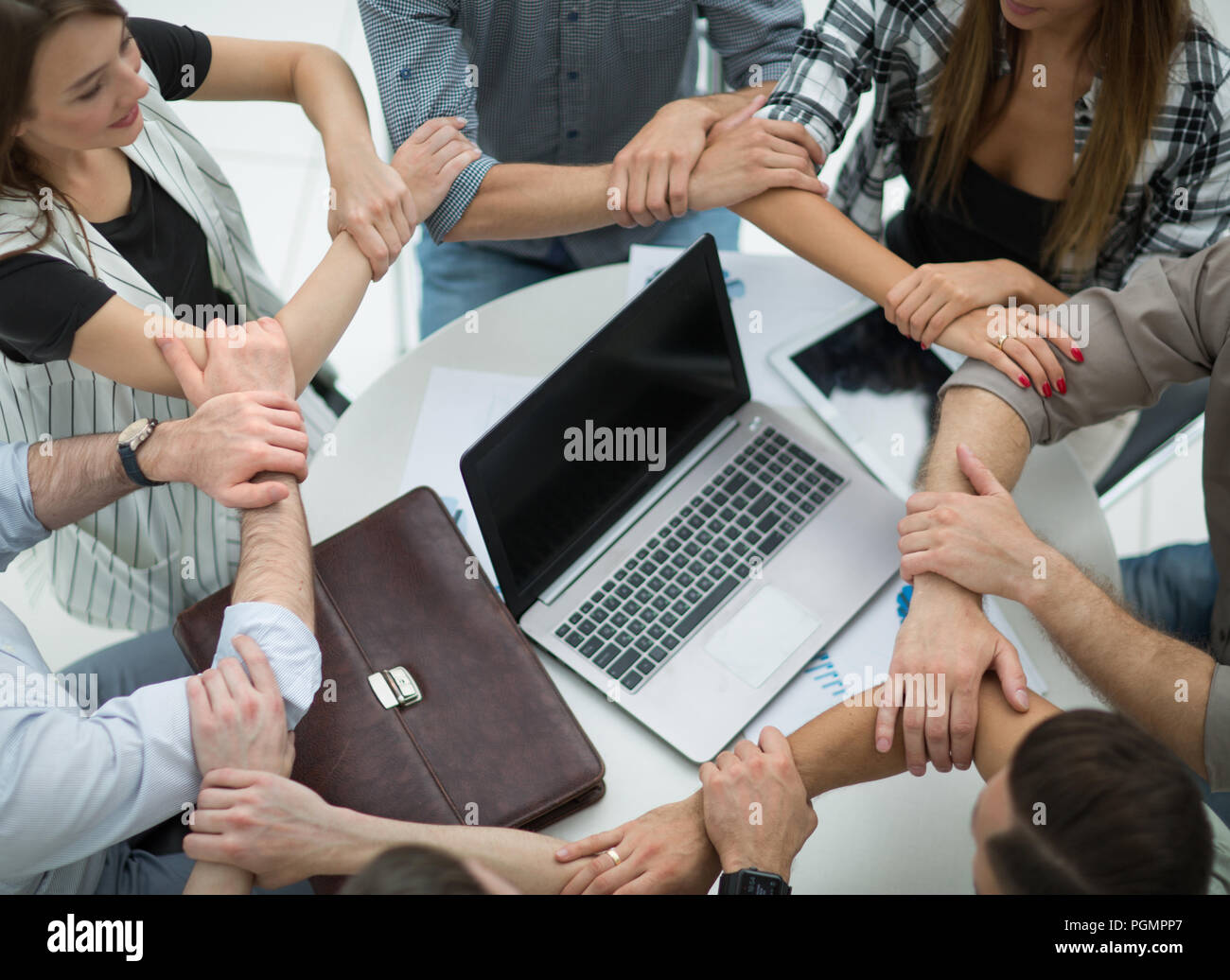 business team forms a circle of hands in the workplace Stock Photo - Alamy