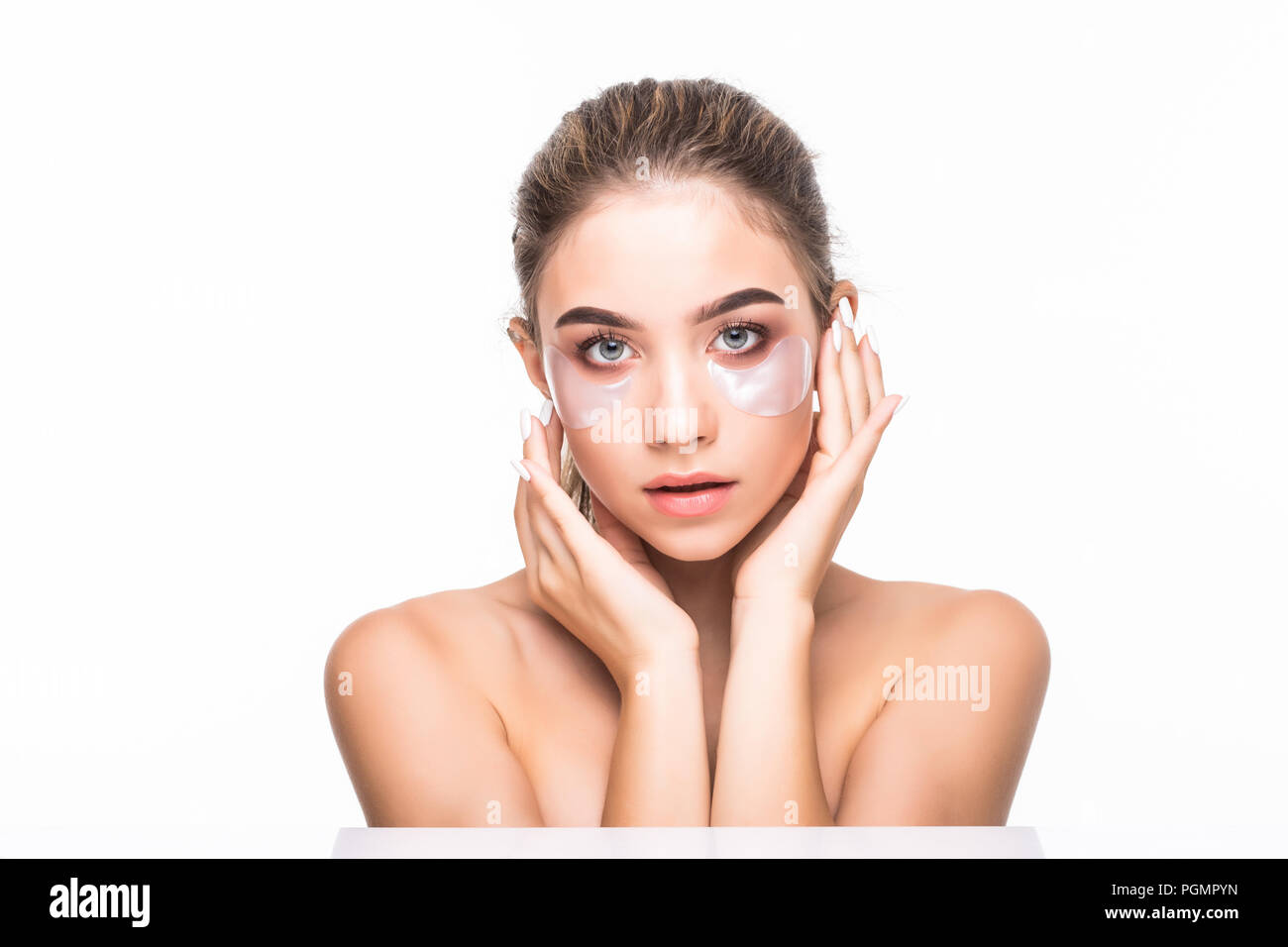 Woman cleaning her face. Beautiful young woman with clear-up patches or ...