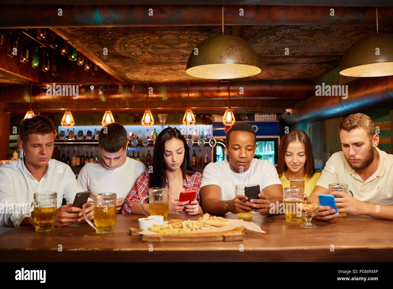 Group of six friends with serious facial expression, sitting with ...