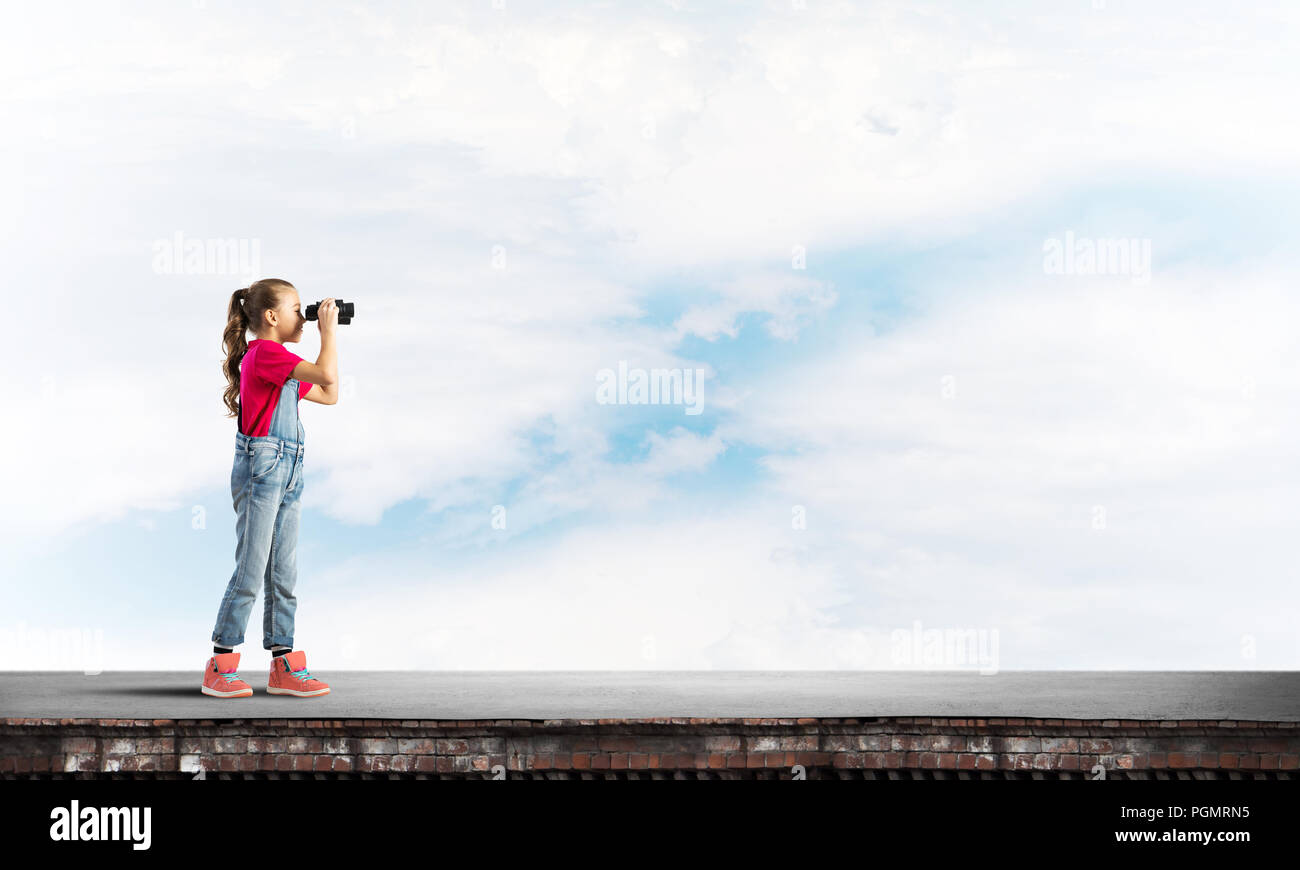 Concept of careless happy childhood with girl of school age looking in ...