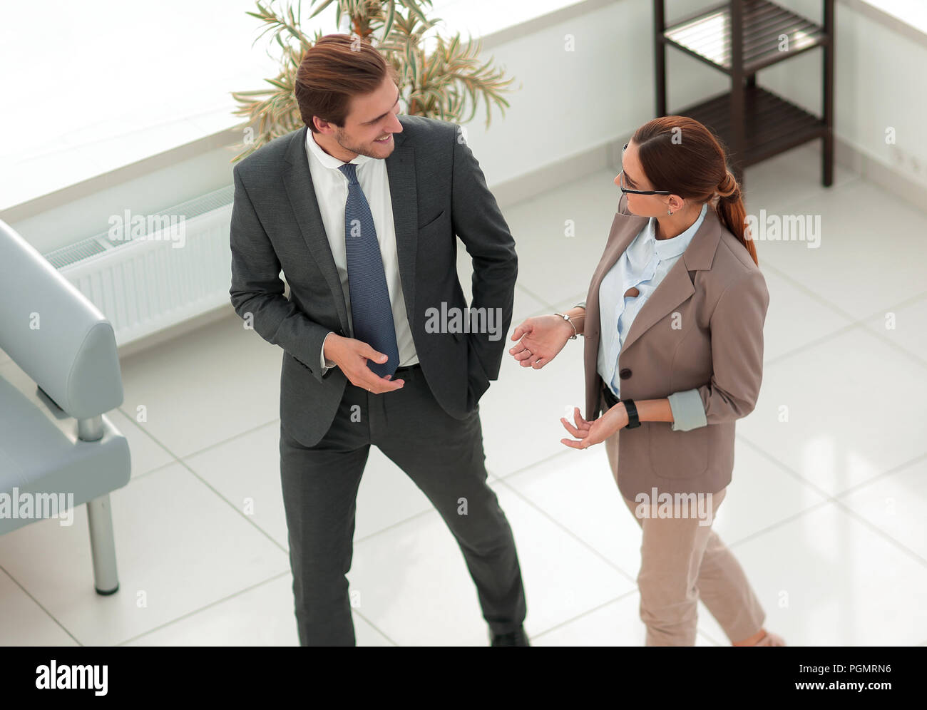 Manager talking to an employee in the office lobby.photo with copy ...