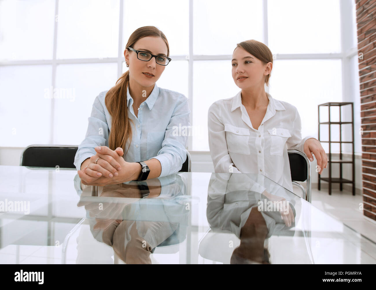 two business women sitting at a table in the conference room.photo with ...