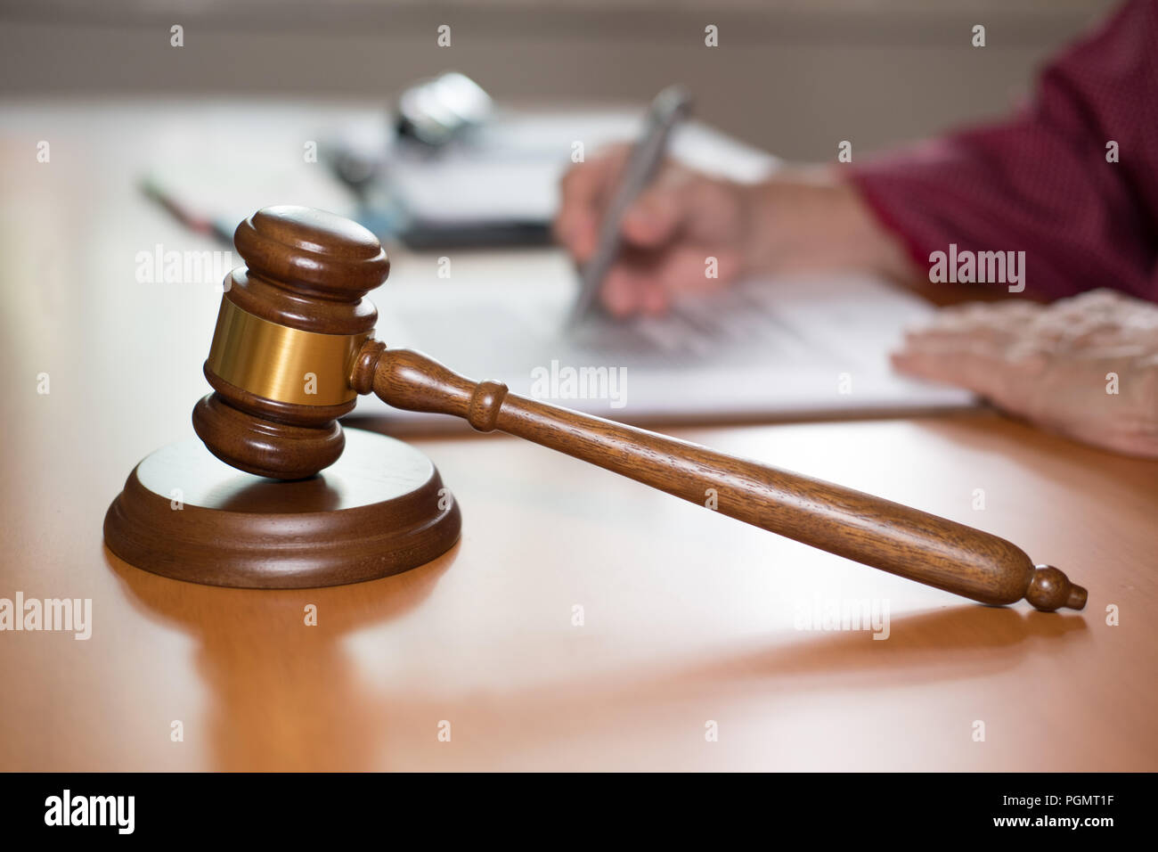 judge writing note with legal law gavel on desk. lawyer attorney ...