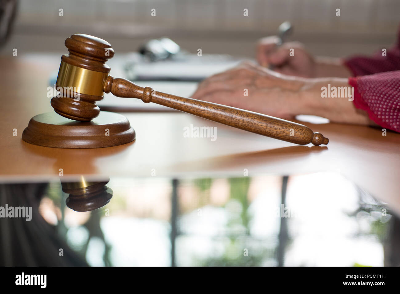 judge writing note with legal law gavel on desk. lawyer attorney ...