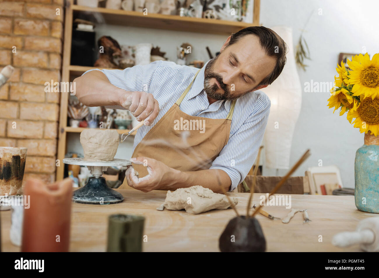 Creative potter smelling aroma sticks working with pottery wheel Stock ...