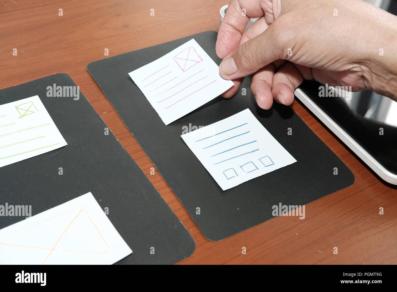 user experience (UX) designer designing web on smart phone layout. UI ...