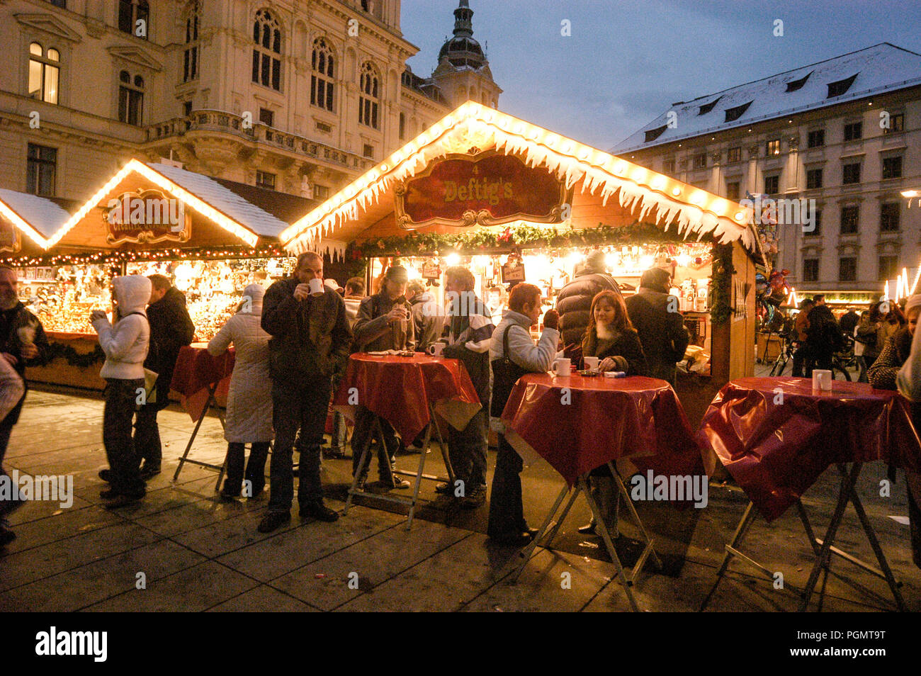 At dusk as shoppers shop and others enjoy a gluhwein ( (hot mulled wine ...