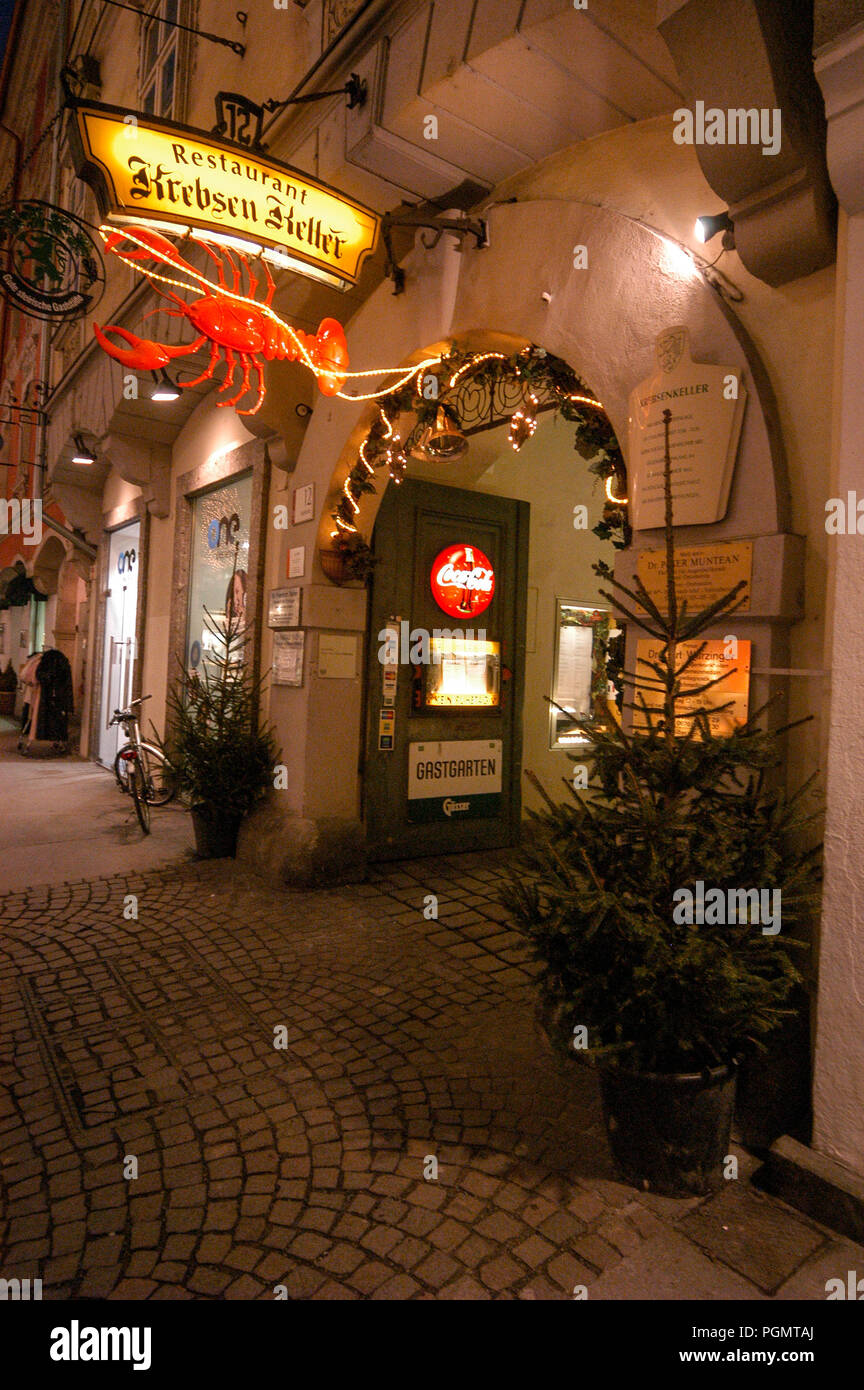 A narrow street of cafes, bierkellers and eateries at night off ...