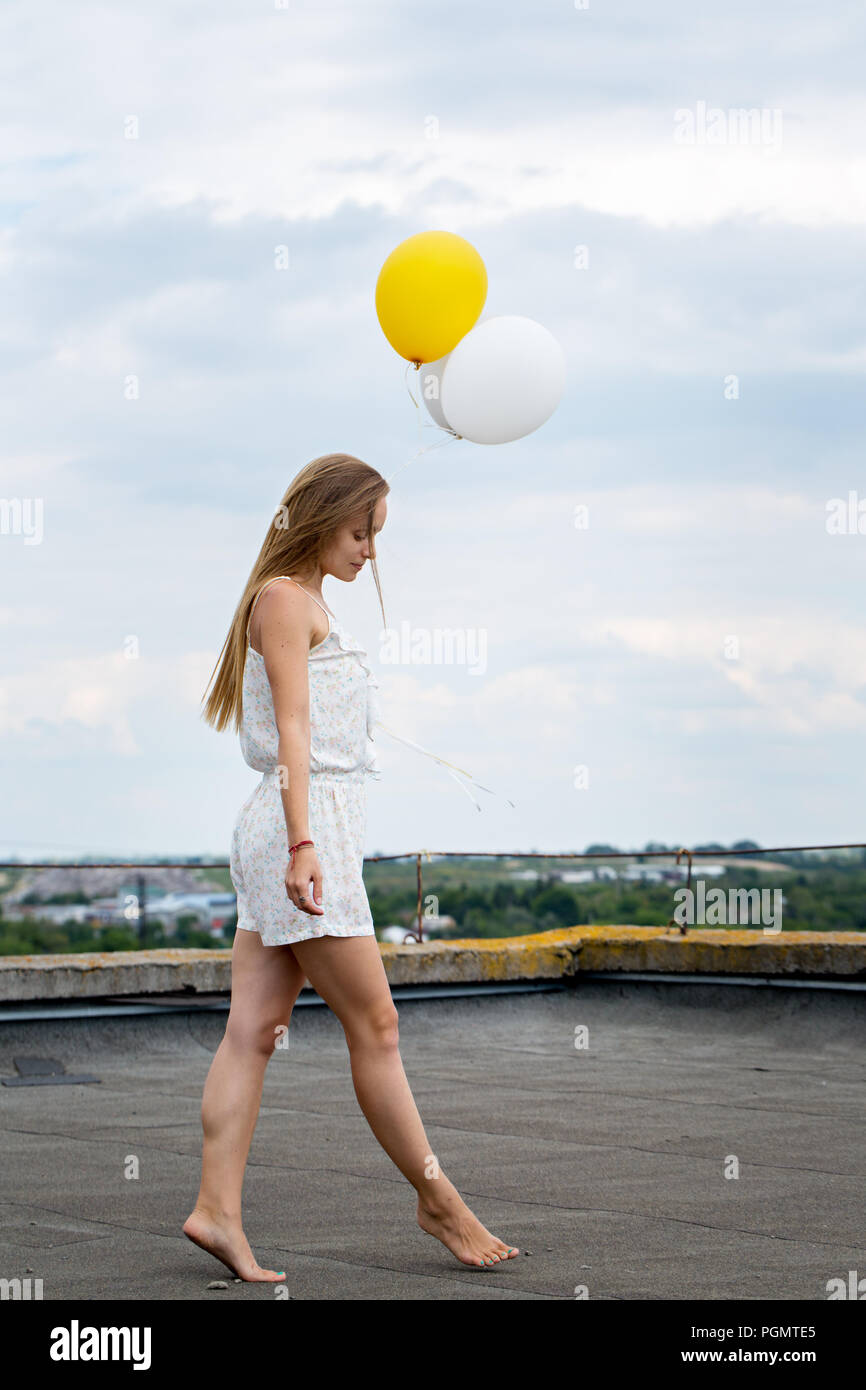 Fragile girl with balloons Stock Photo - Alamy