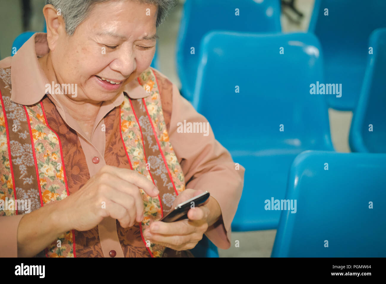 elder woman holding mobile phone. elderly senior female texting message ...