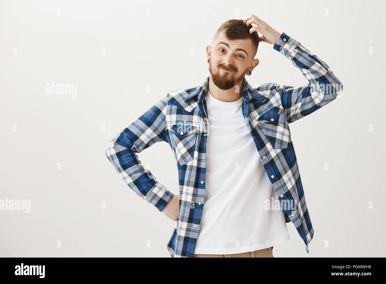 Guy looking at instruction, being questioned. Confused funny european ...