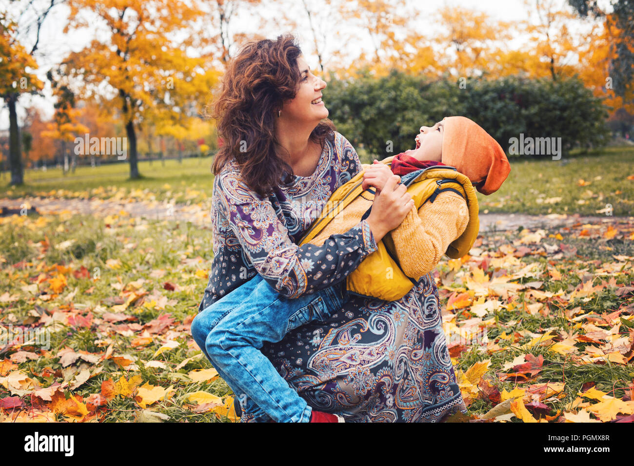 Happy mother and son embracing outdoors. Love care and positive ...
