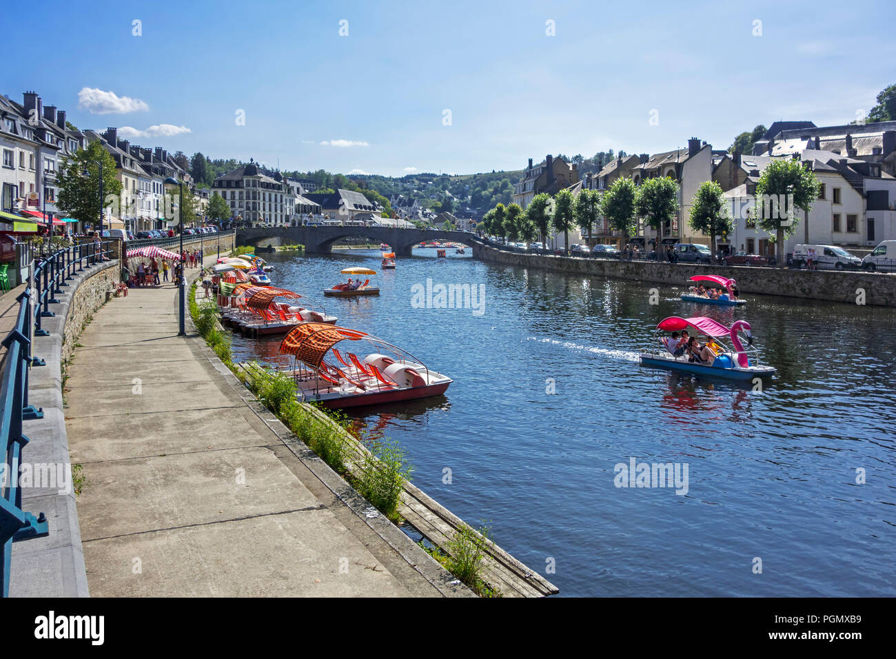 Paddle boats with tourists on the Semois river in front of the bridge ...