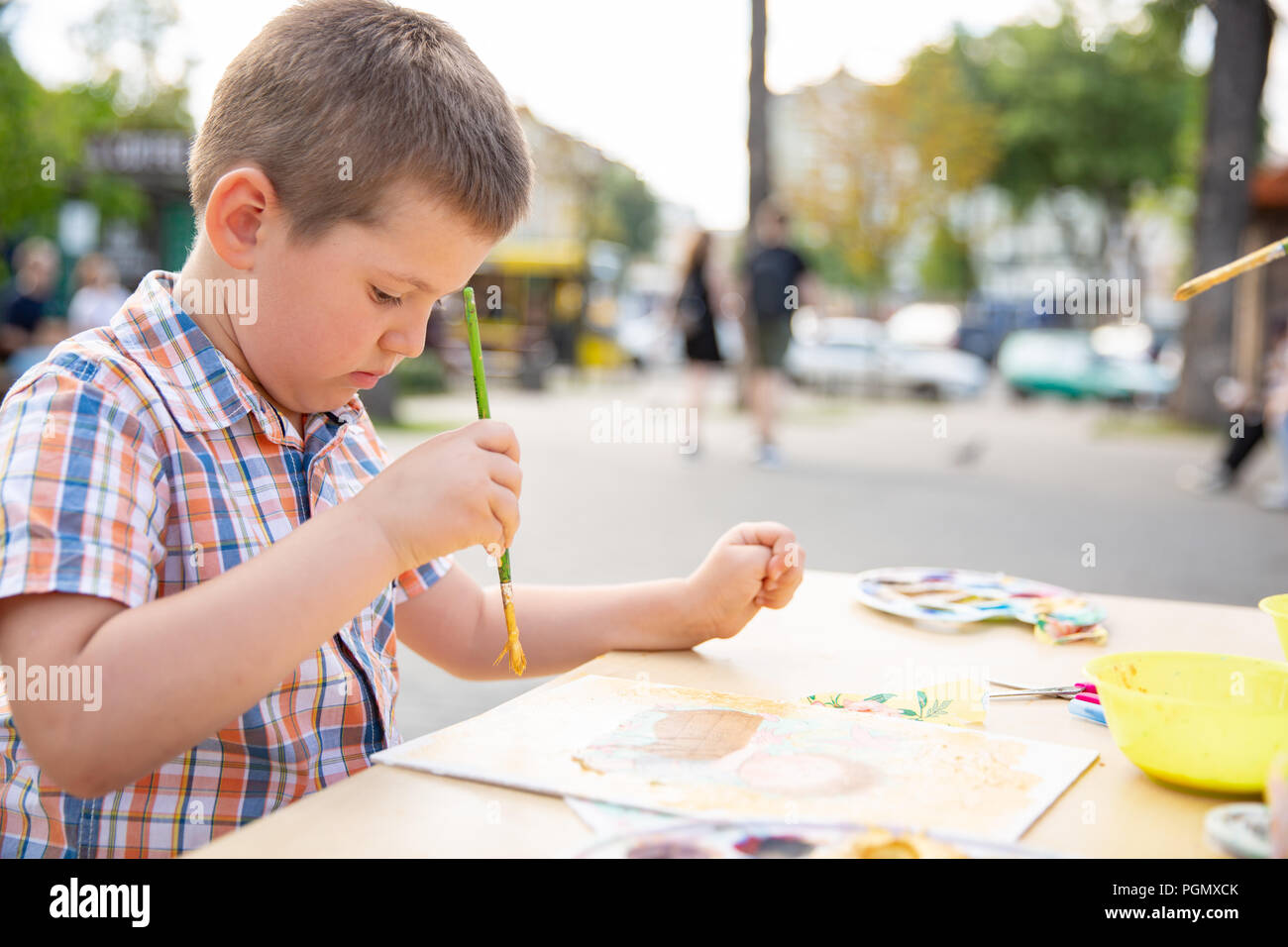 Cute little boy drawing with colorful paints in fall park. Creative ...